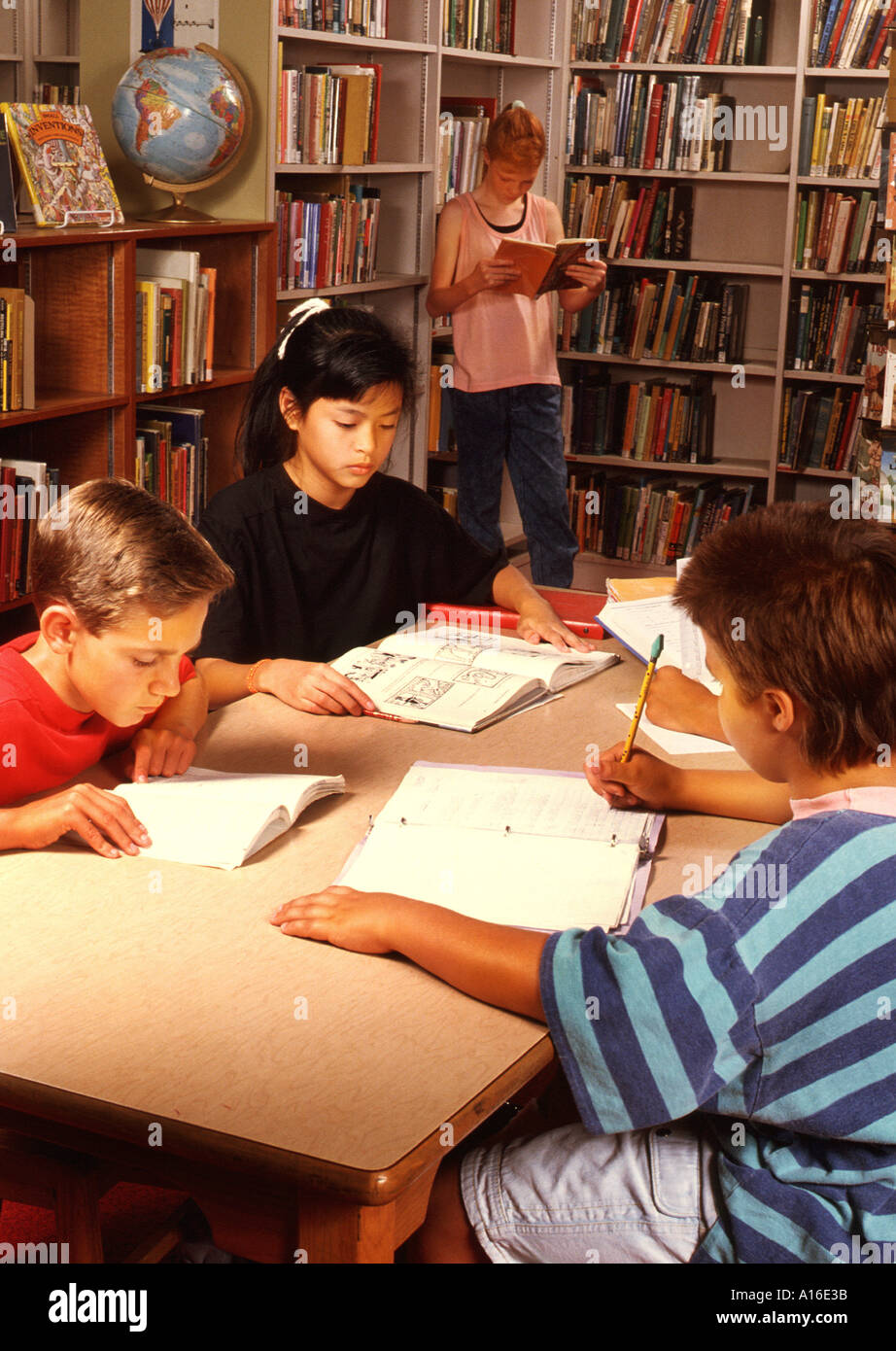 Education Students grade 5 7 studying in library Stock Photo - Alamy