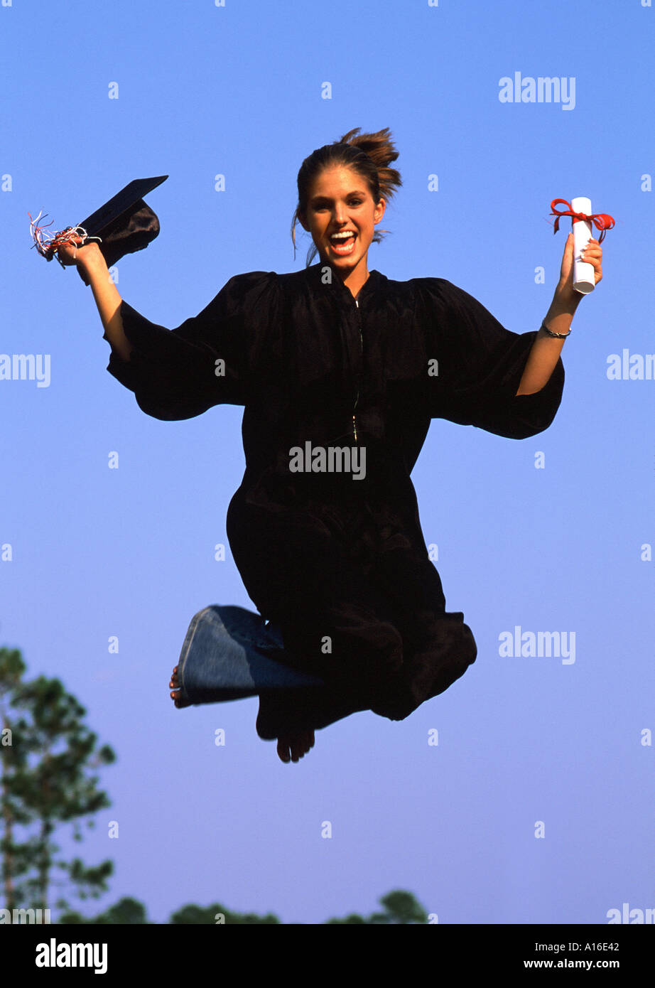 Girl high school graduate jumping on trampoline smiling of Success and ...