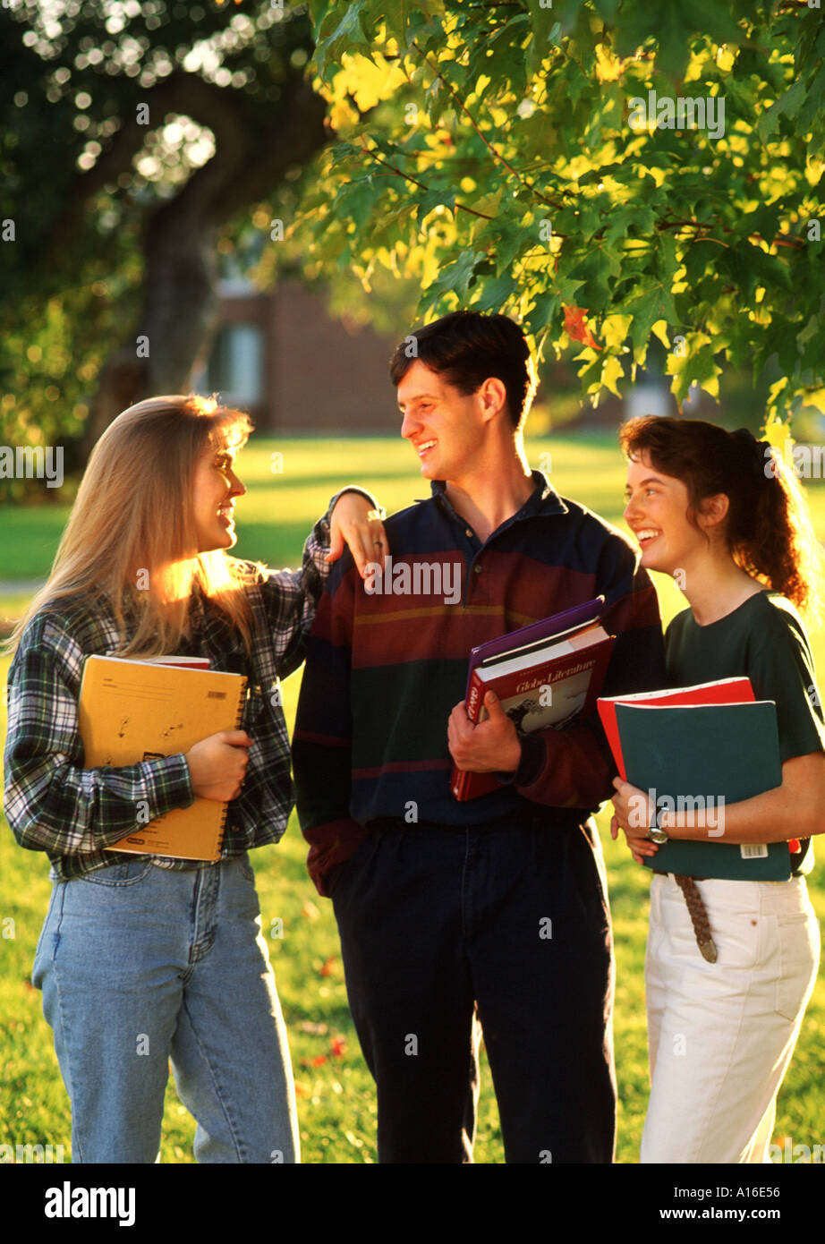 Attractive young college students talking together on campus Stock ...