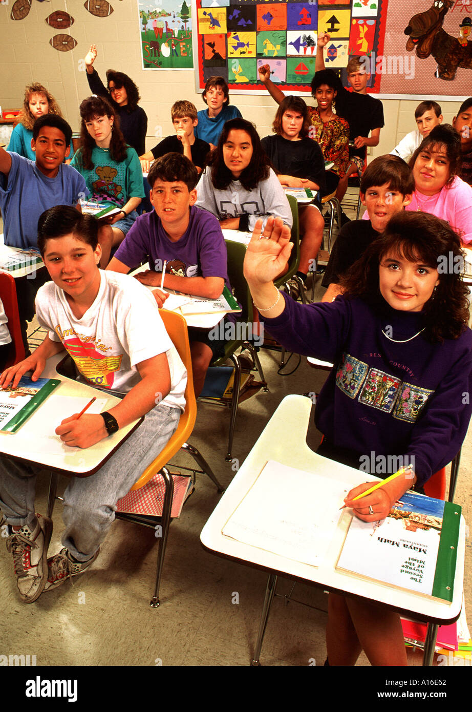Education Students raising hands in 8th grade math class Stock Photo ...