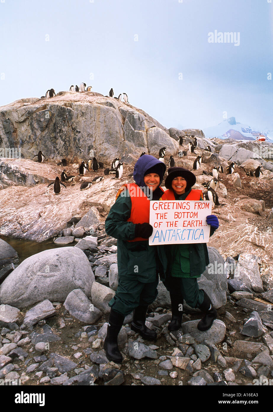 Tourist couple with sign in Antarctica Stock Photo - Alamy