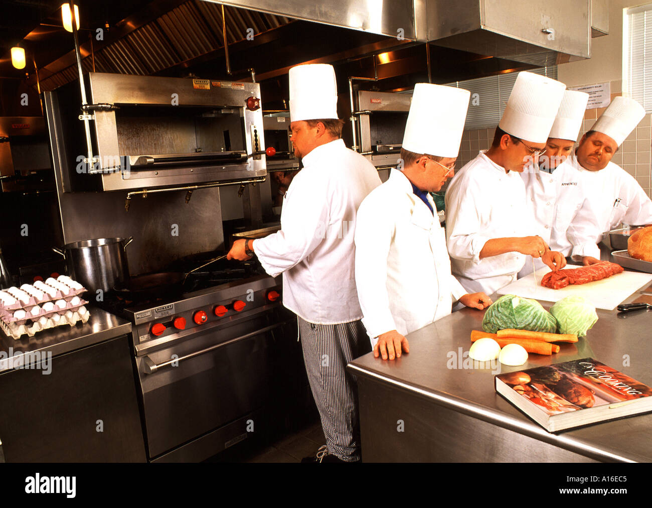 Food preparation Learning to become a chef in kitchen with apprentices ...