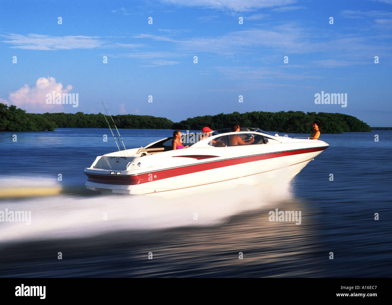 Family having fun on a boat going fast on the water Stock Photo - Alamy
