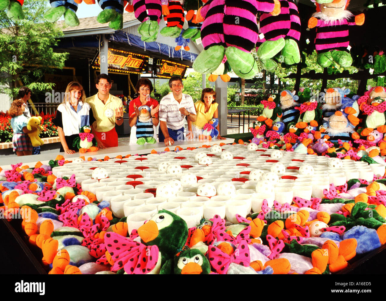Carnival Circus Family playing ball toss Stock Photo - Alamy