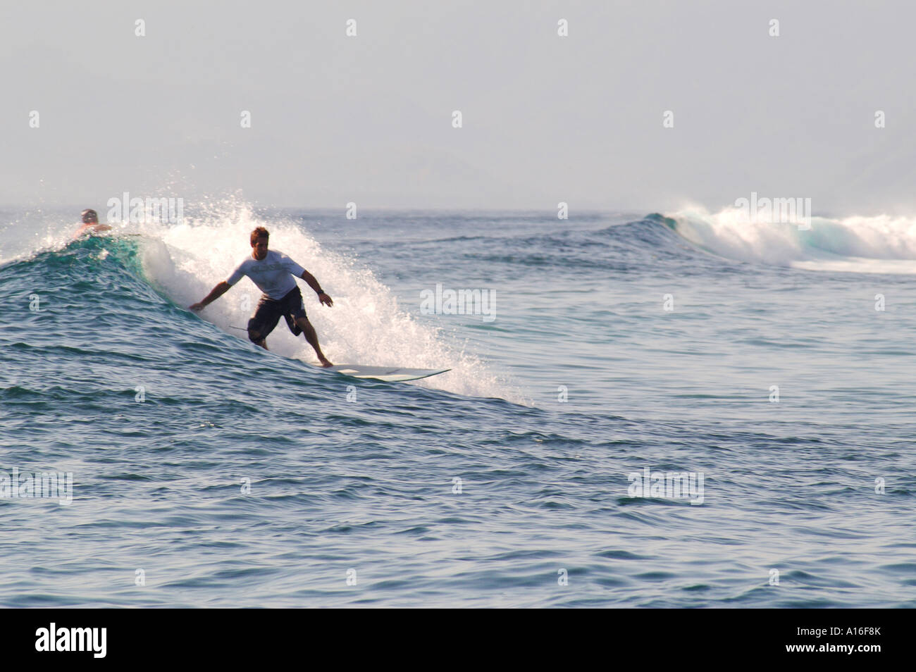 A surfer lines up a wave on the shores of Bali, Indonesia Stock Photo ...