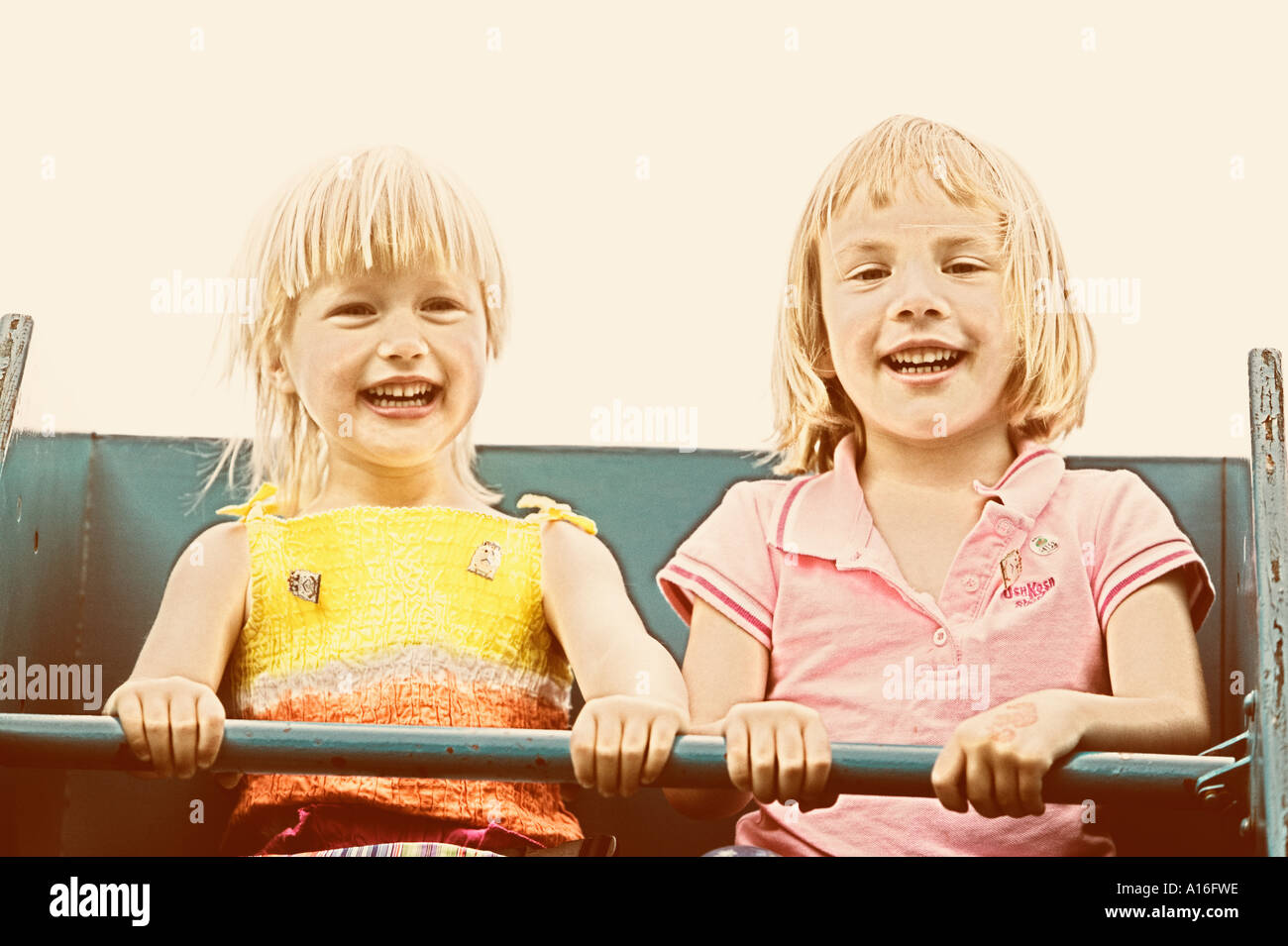 3 year old girl friends on Ferris Wheel Stock Photo - Alamy