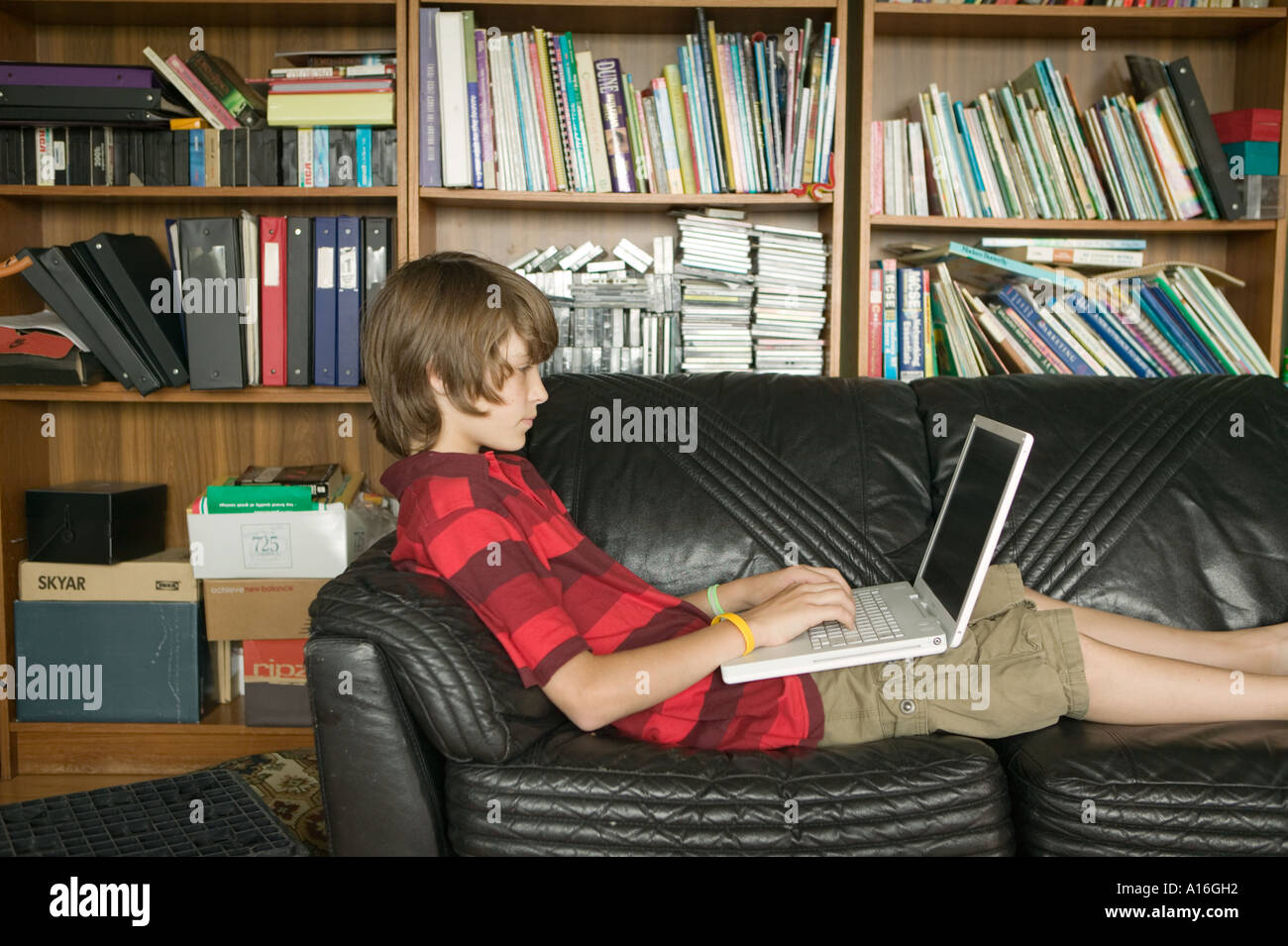 13 year old causcasian male using a laptop computer Stock Photo - Alamy