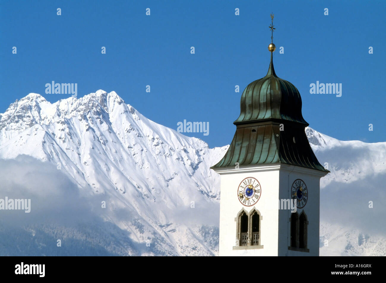 church spire with snow covered mountains, Tyrol, Austria Stock Photo ...