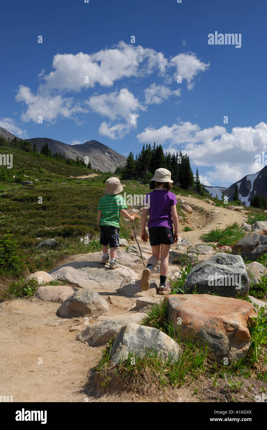 Brother and sister hiking up a mountain Stock Photo - Alamy