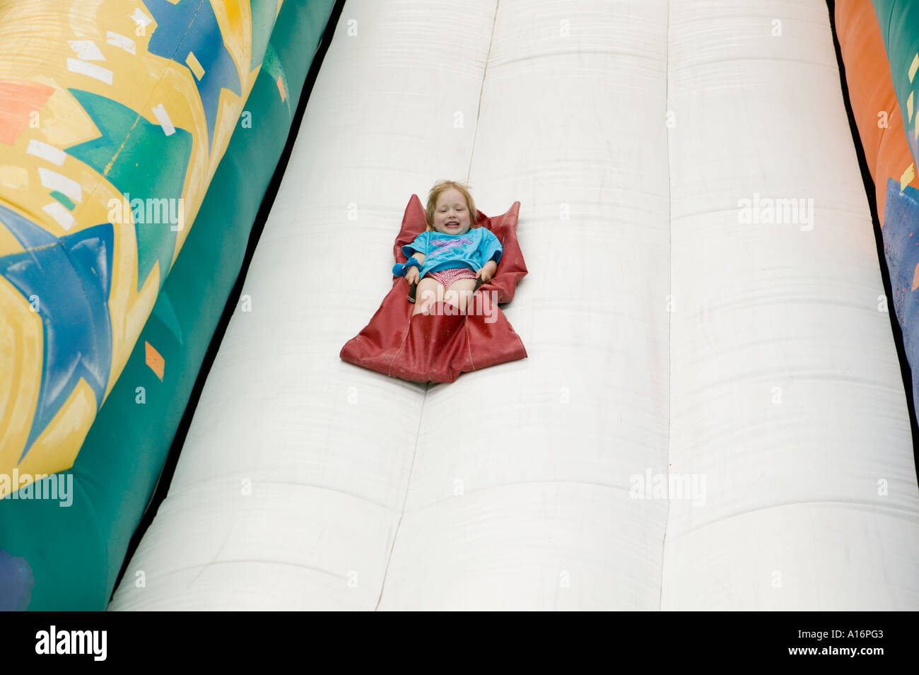 Young girl 3 yrs on inflatable slide Stock Photo - Alamy