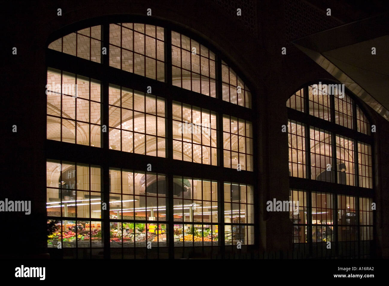 arch top windows on a supermarket in New York city at night under the ...