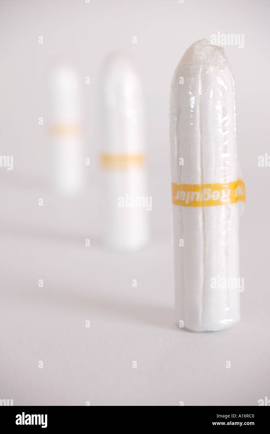 Three wrapped tampons on a white background Stock Photo - Alamy