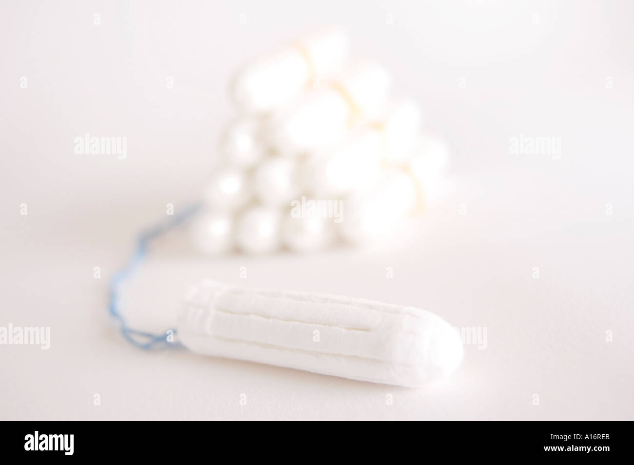 Single unwrapped tampon on a white background Stock Photo - Alamy