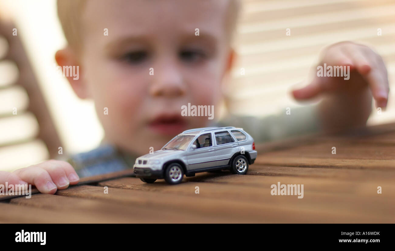 Little boy playing with a car Stock Photo - Alamy