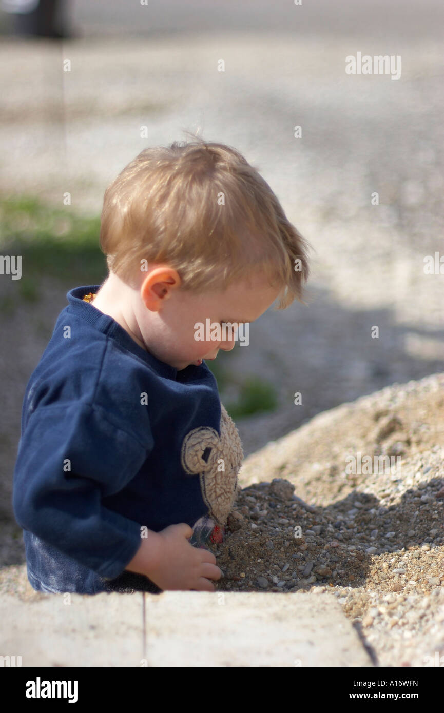 little boy playing with sand Stock Photo - Alamy