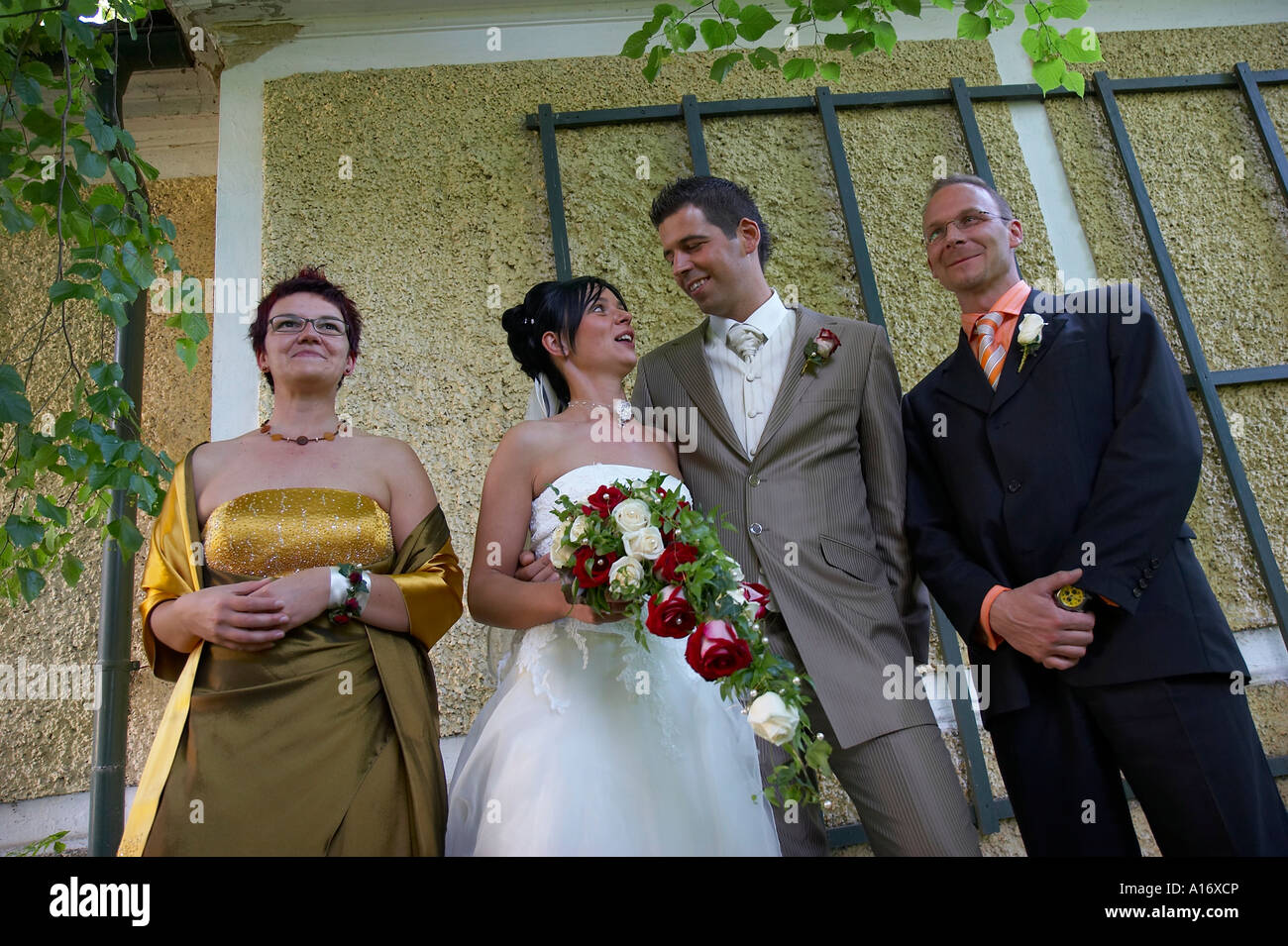bridal couple with best man and witness to marriage Stock Photo - Alamy