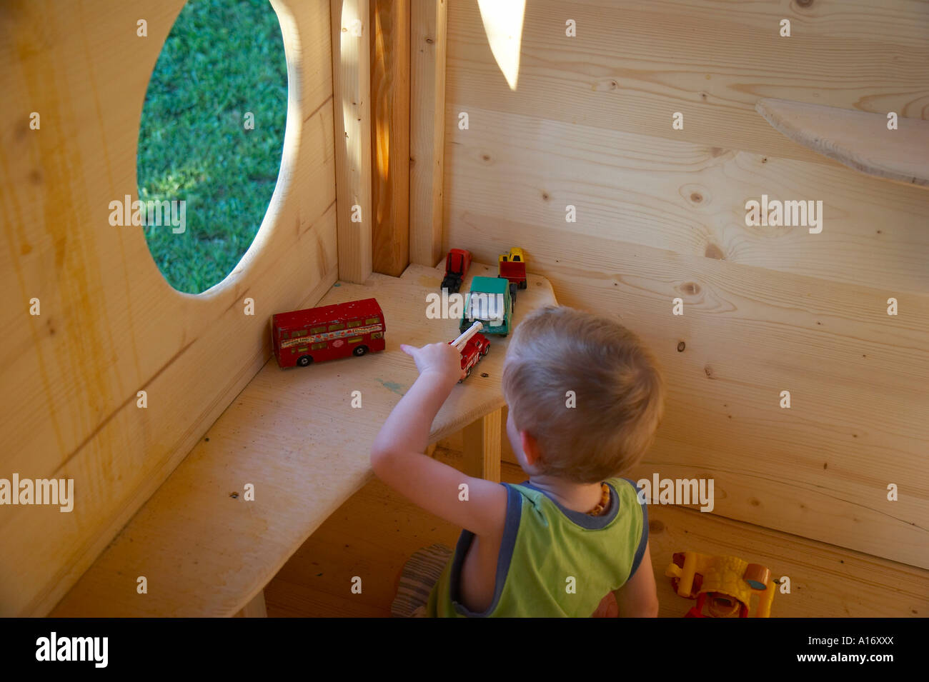 little boy playing in wooden hut Stock Photo - Alamy