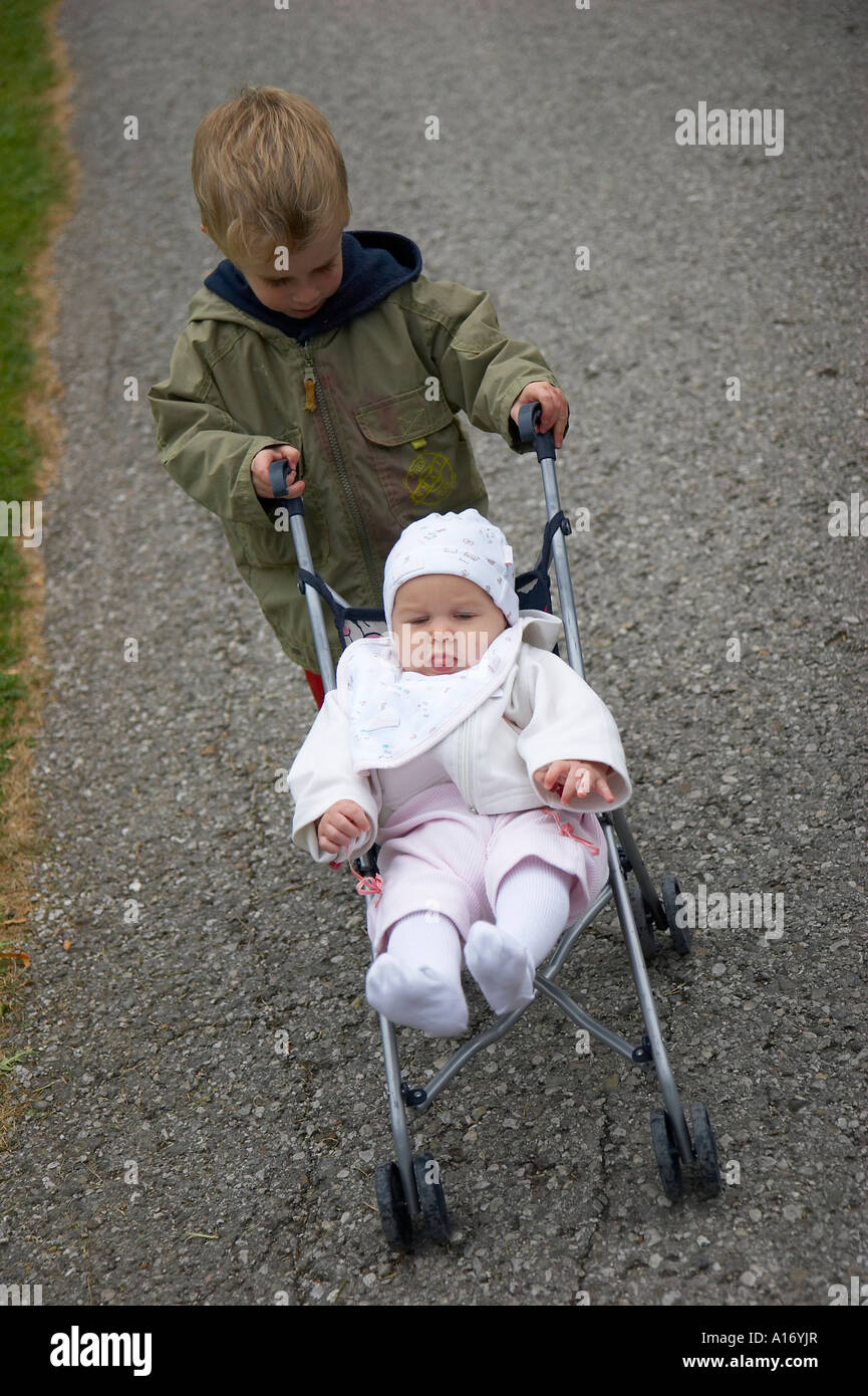 little boy with baby in stroller Stock Photo - Alamy