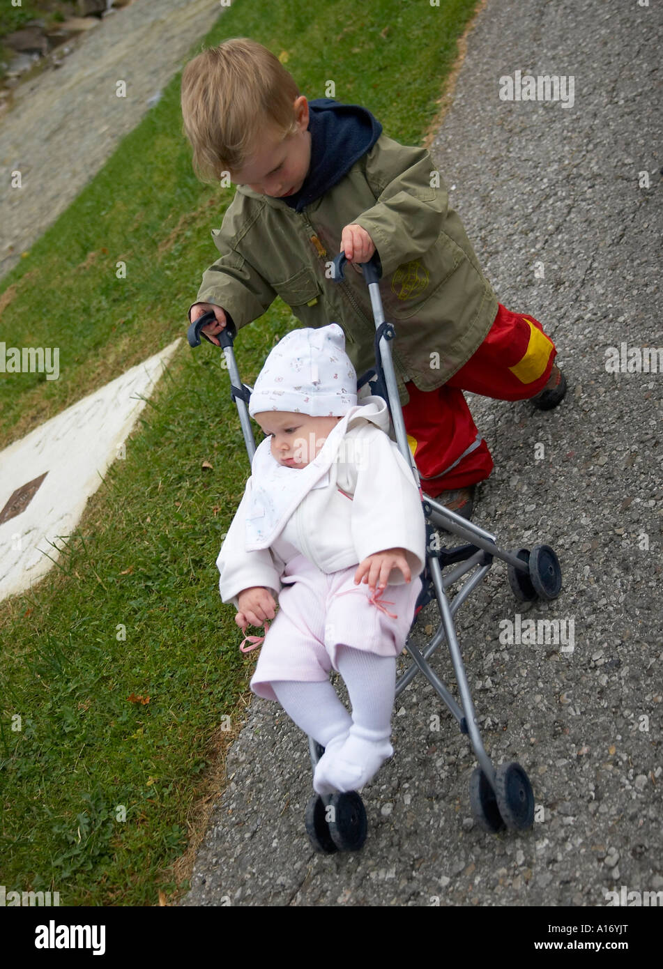 little boy with baby in stroller Stock Photo - Alamy