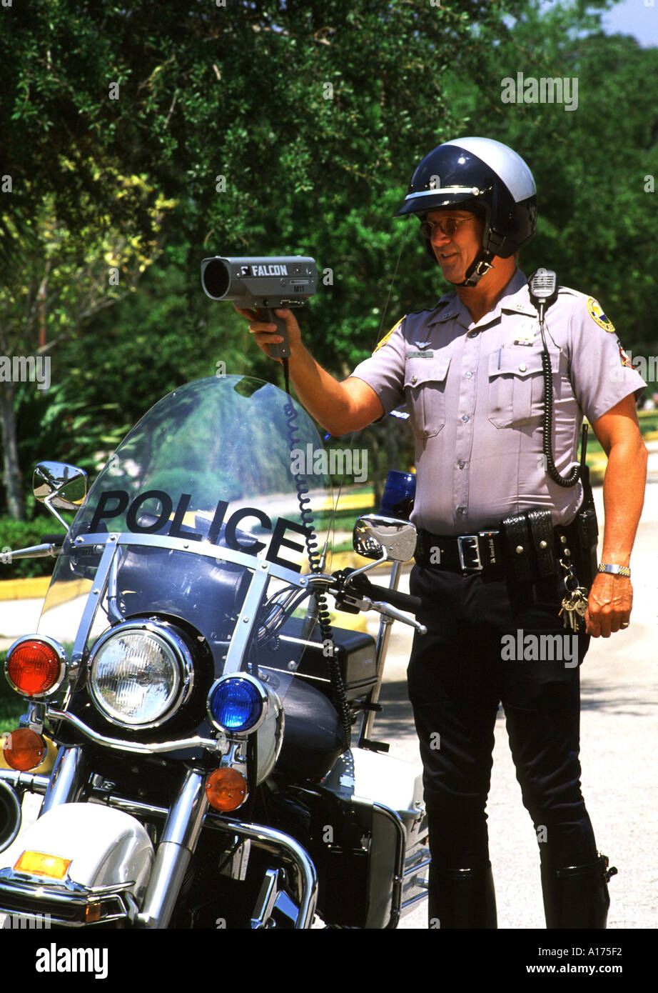 Police officer checking speed with radar gun hi-res stock photography ...