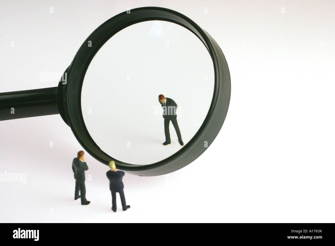 figures and a magnifier Stock Photo - Alamy