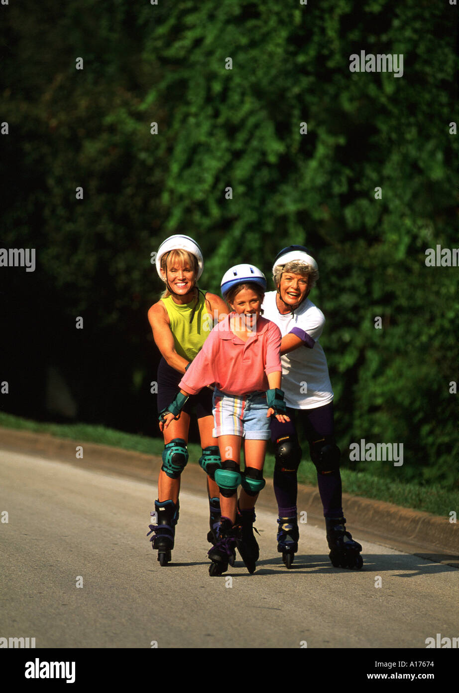 3 generations of women rollerblading together Stock Photo - Alamy