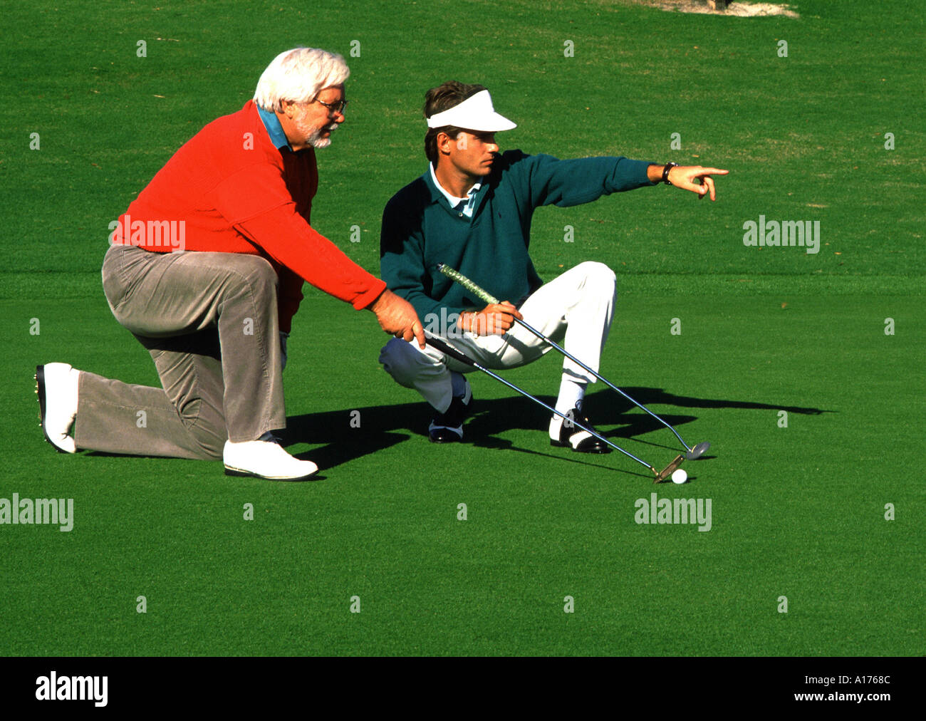 Two men lining up putt on well kept golf course Stock Photo - Alamy