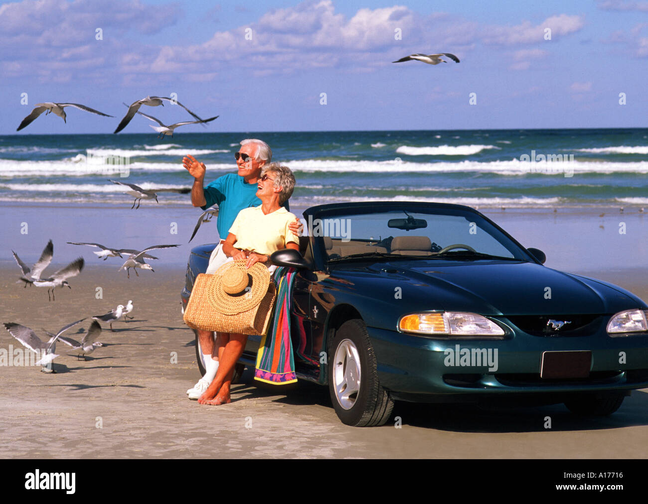 Retired couple relaxing on the beach Stock Photo - Alamy