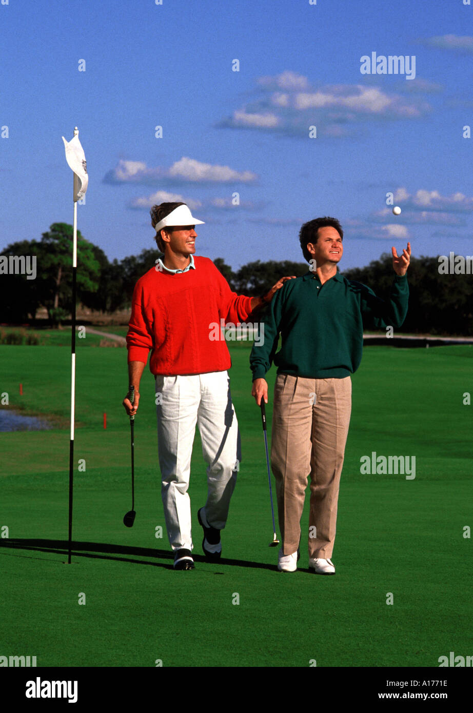 Two men playing golf together Stock Photo - Alamy