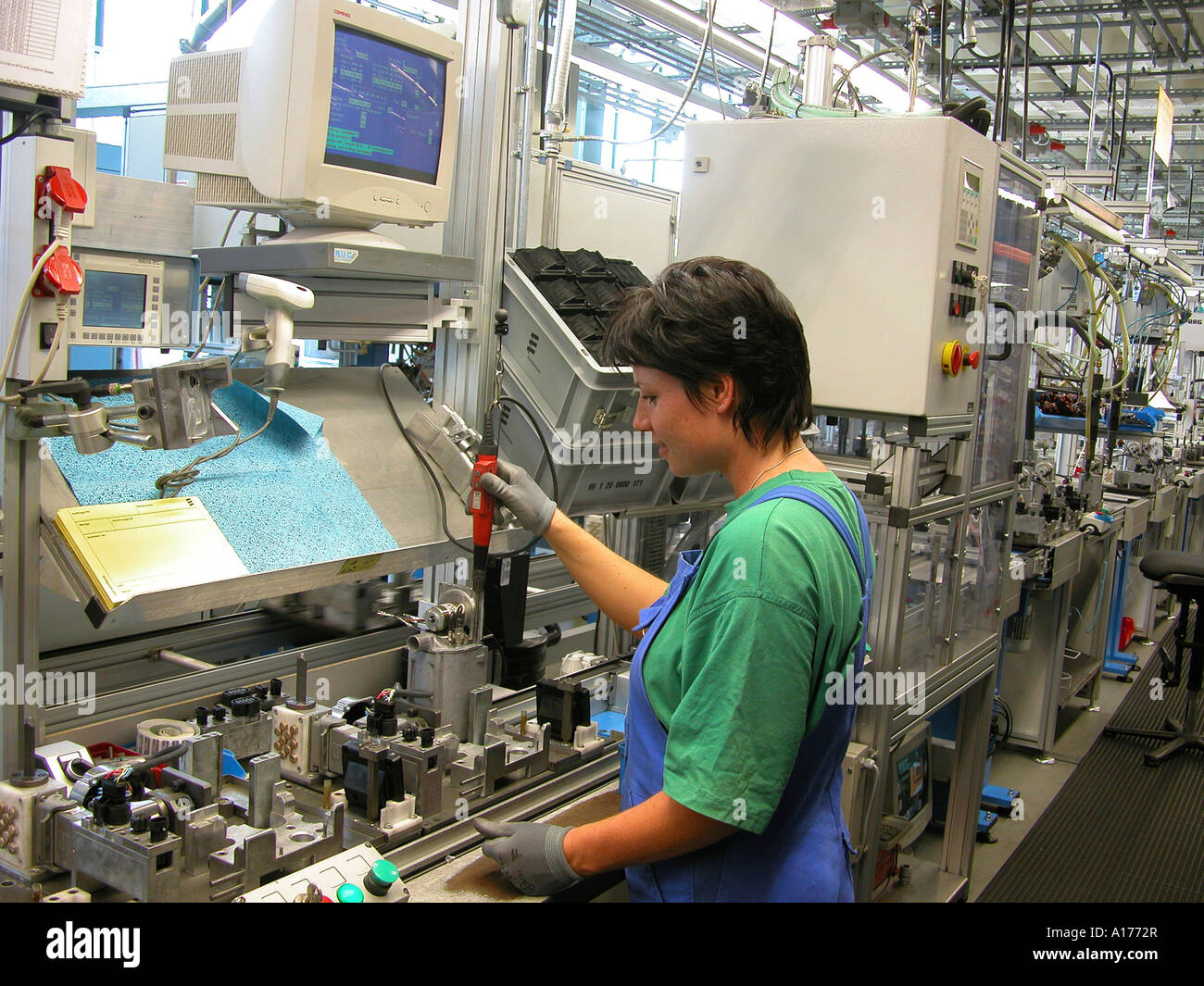 Female worker in the industry at the assembly line Stock Photo - Alamy