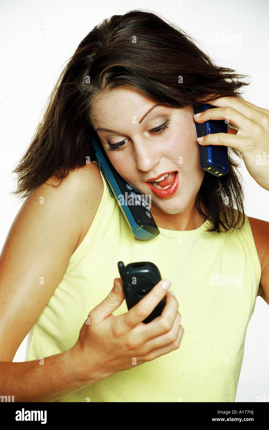 Woman with several telephones Stock Photo - Alamy