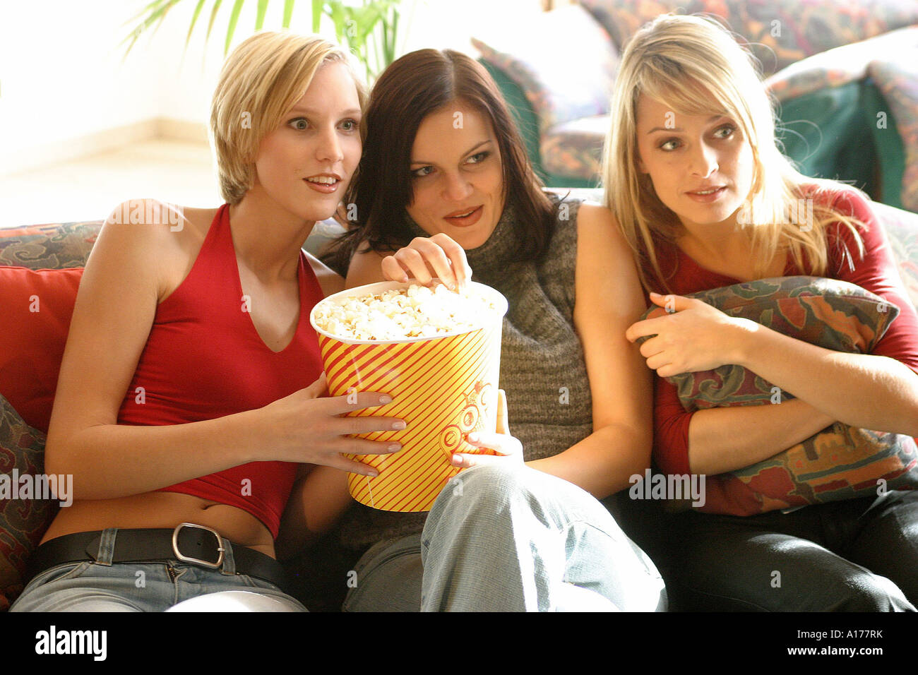 Friends watching television Stock Photo - Alamy