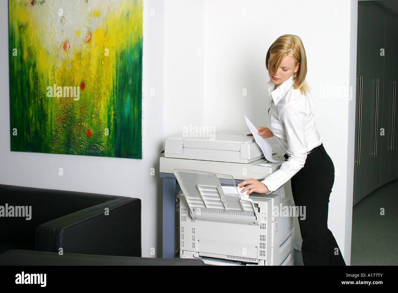Secretary at the copier Stock Photo - Alamy