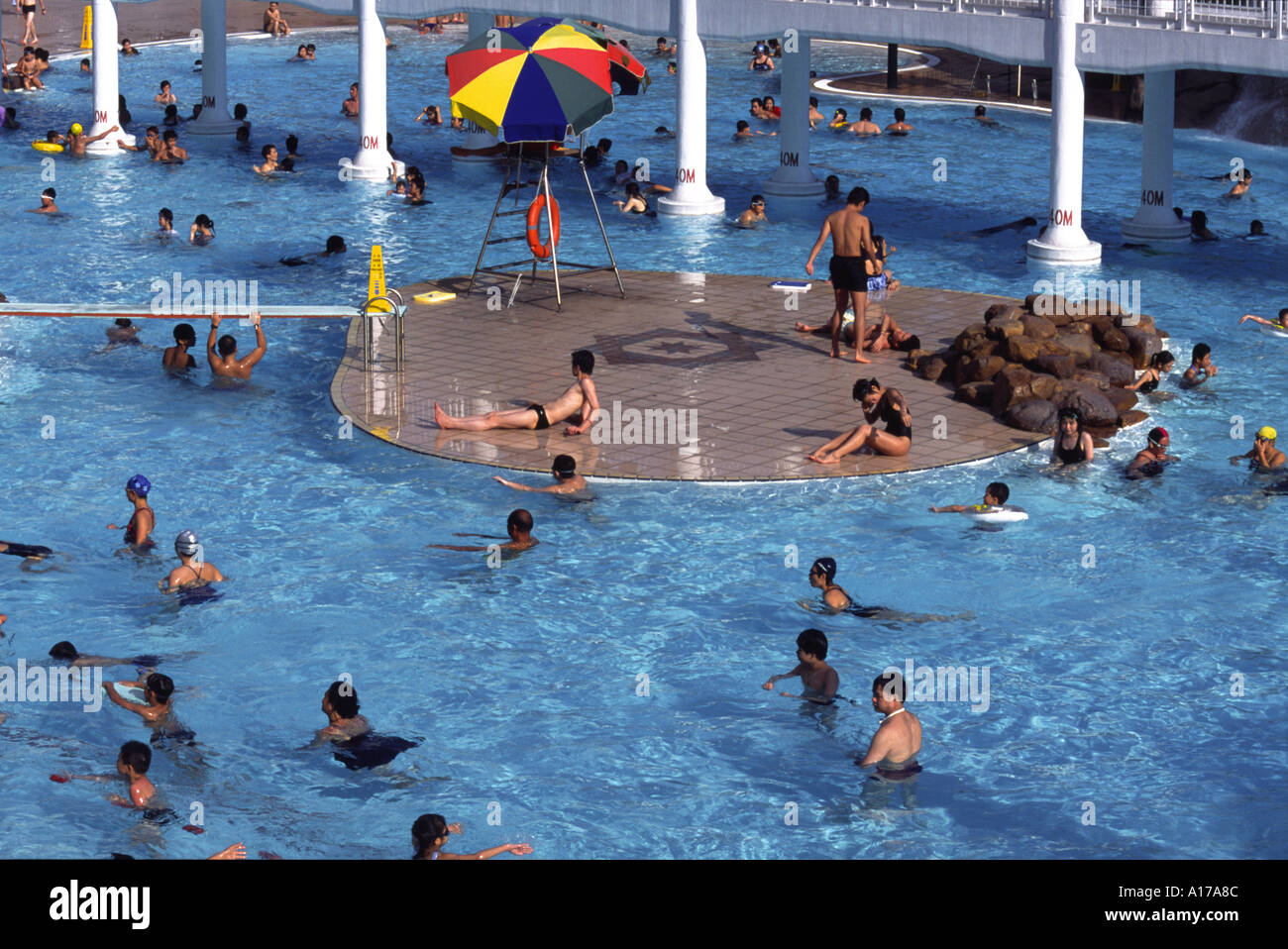People enjoying a summer afternoon in a public swimming pool in Hong ...