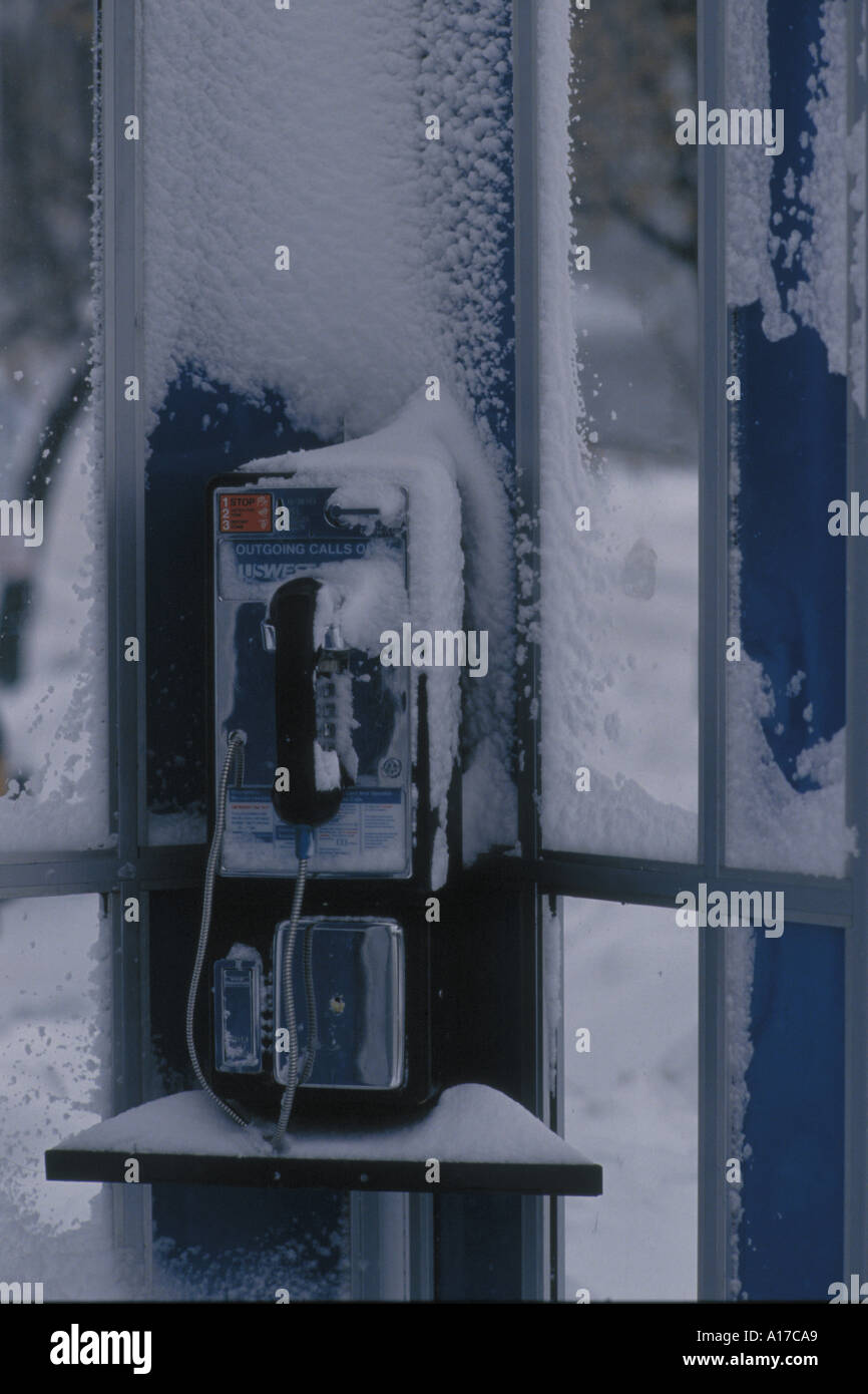 snow covered telephone in phone booth Stock Photo - Alamy