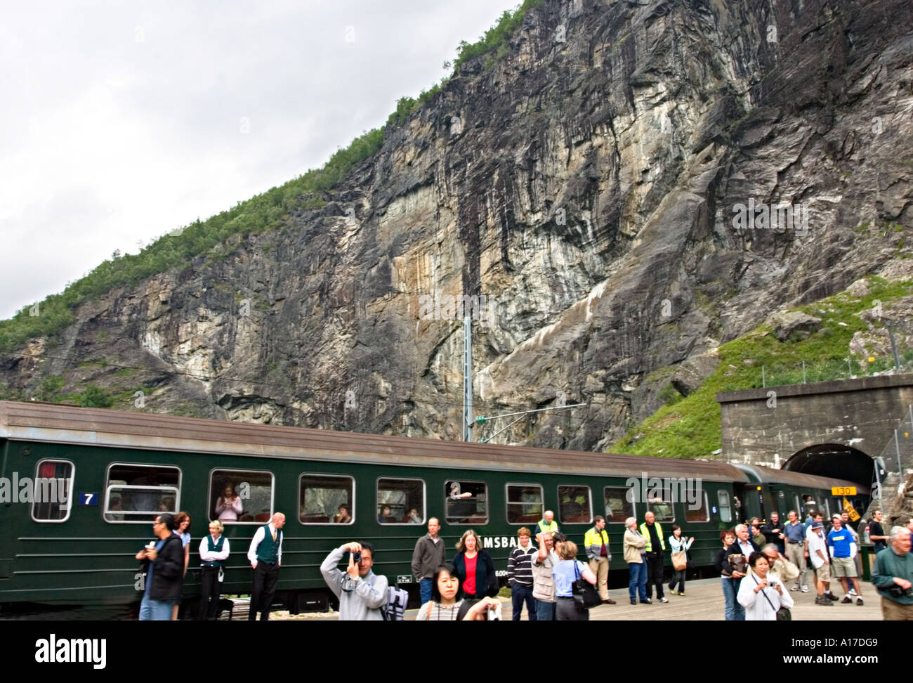 Train and passengers at Kjosfossen waterfall Flam Railway stop Norway ...