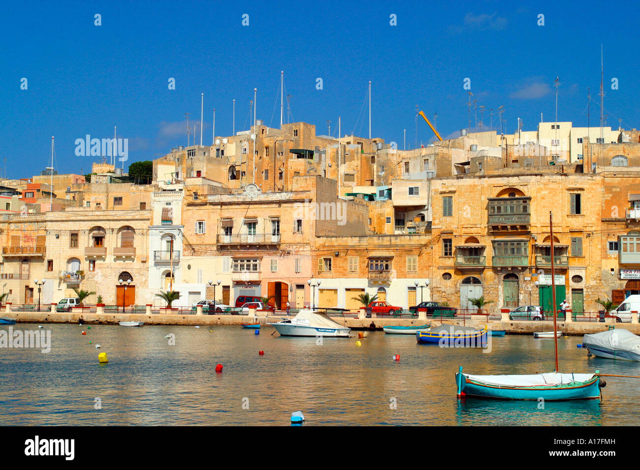 Brightly painted Maltese boats on blue water in summer, Malta Stock ...