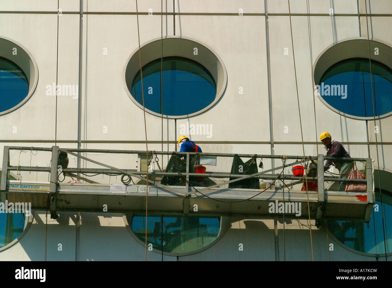 Men cleaning windows on a Tall building in Hong Kong Stock Photo - Alamy