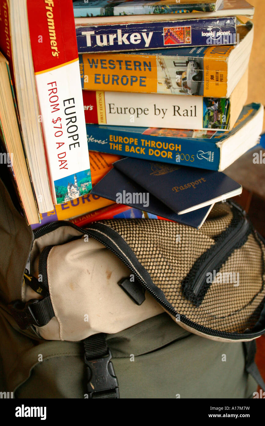 Travel books spilling out of a well traveled Backpack Stock Photo - Alamy