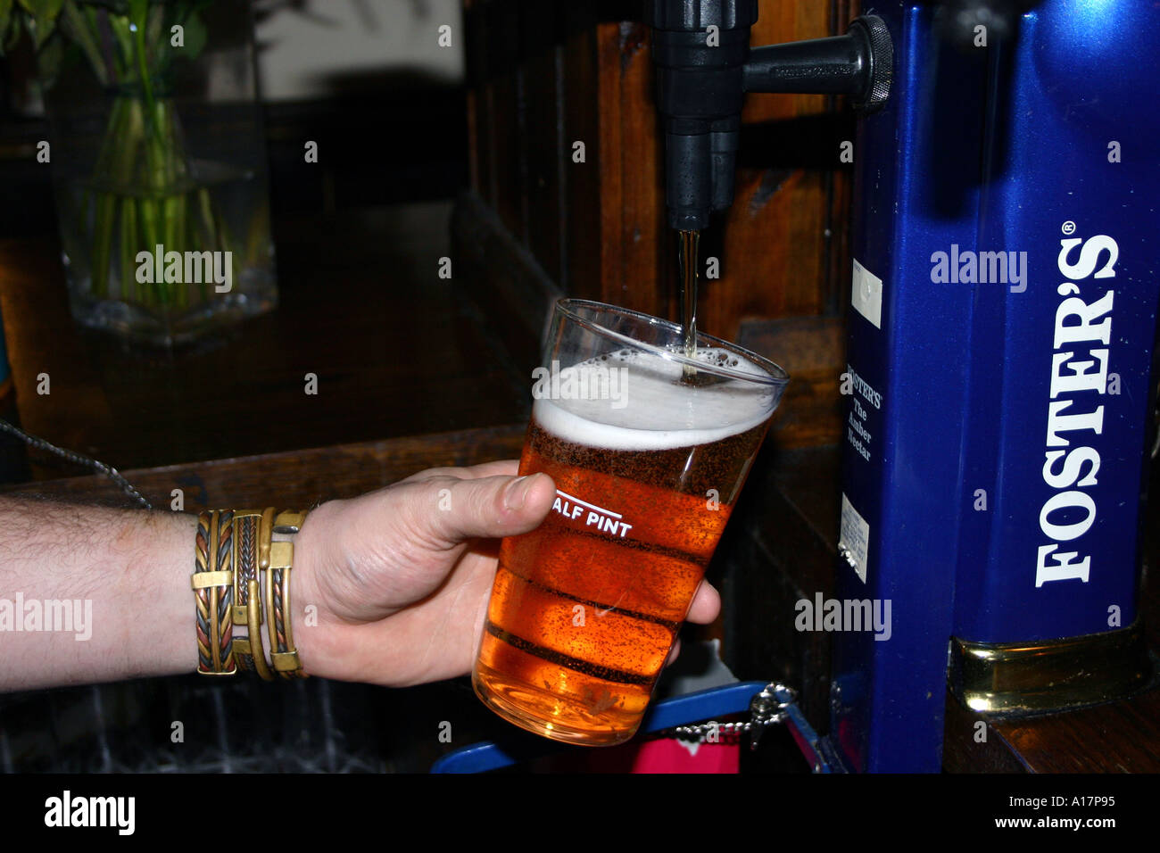 Pouring a pint of Lager Stock Photo - Alamy