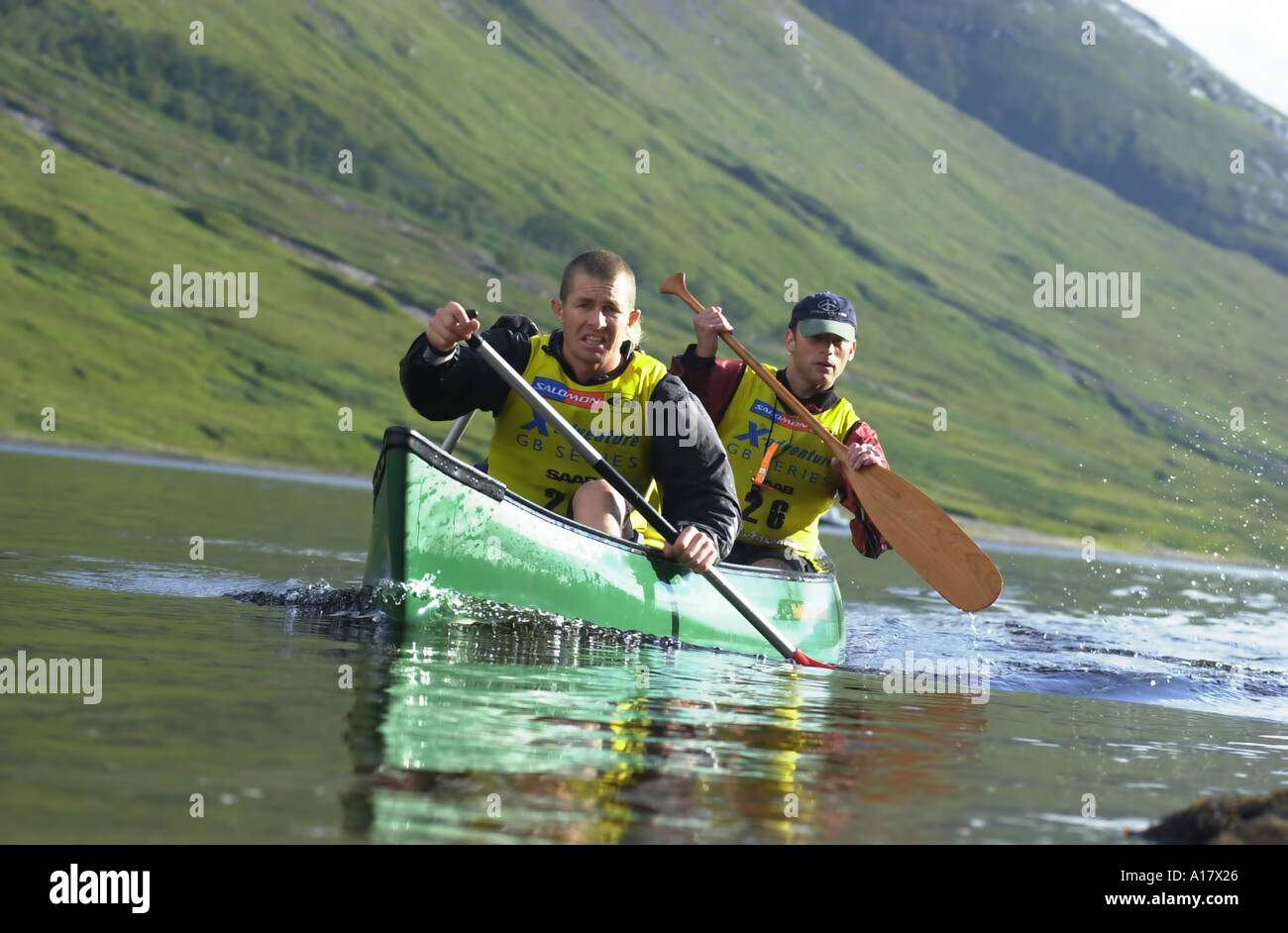 Adventure athletes paddling open canoe Stock Photo - Alamy