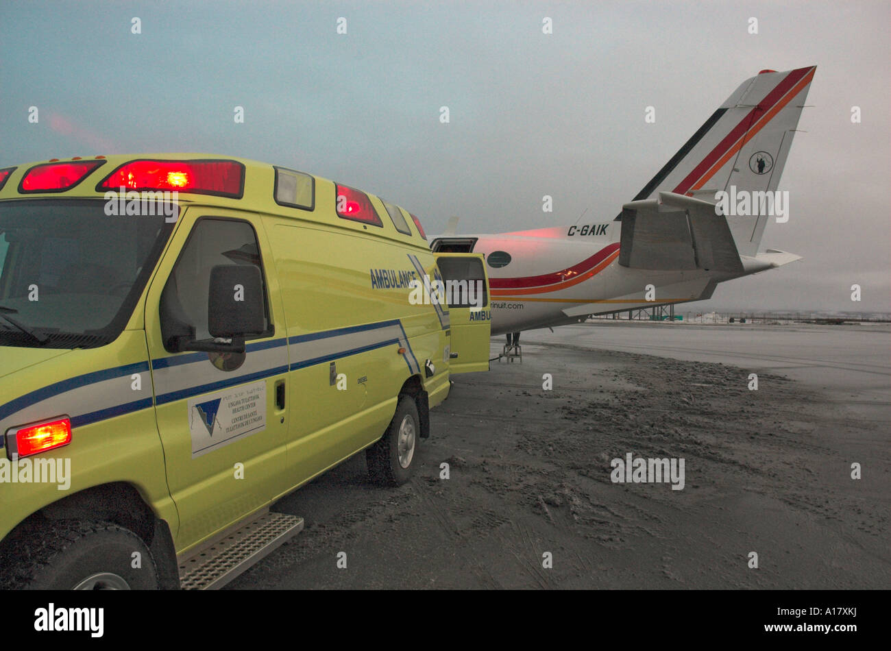An ambulance by a plane preparing for an emergency medical evacuation ...