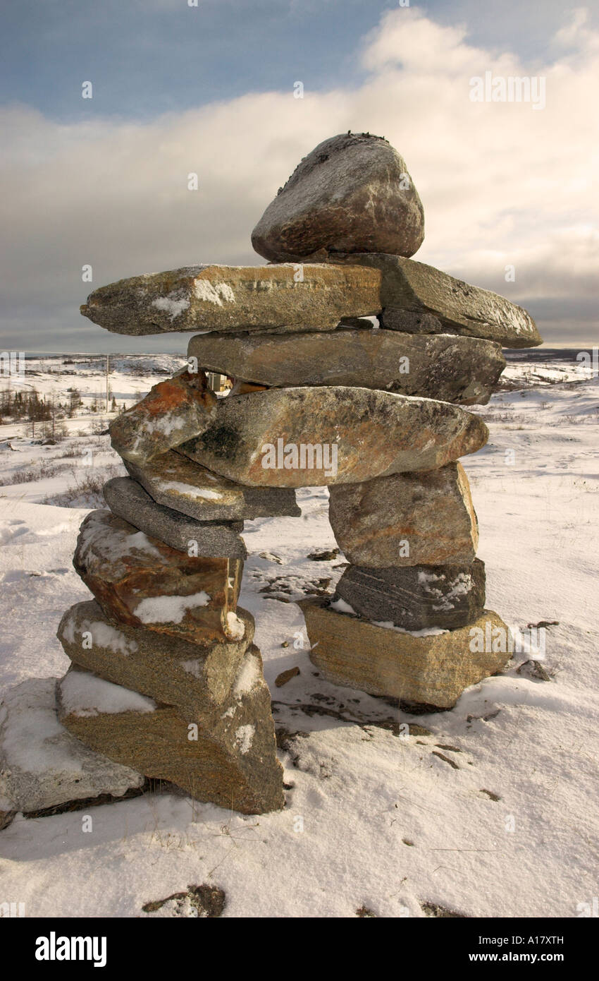 An inukshuk on a hill overlooking the arctic village of Kuujjuaq Stock ...
