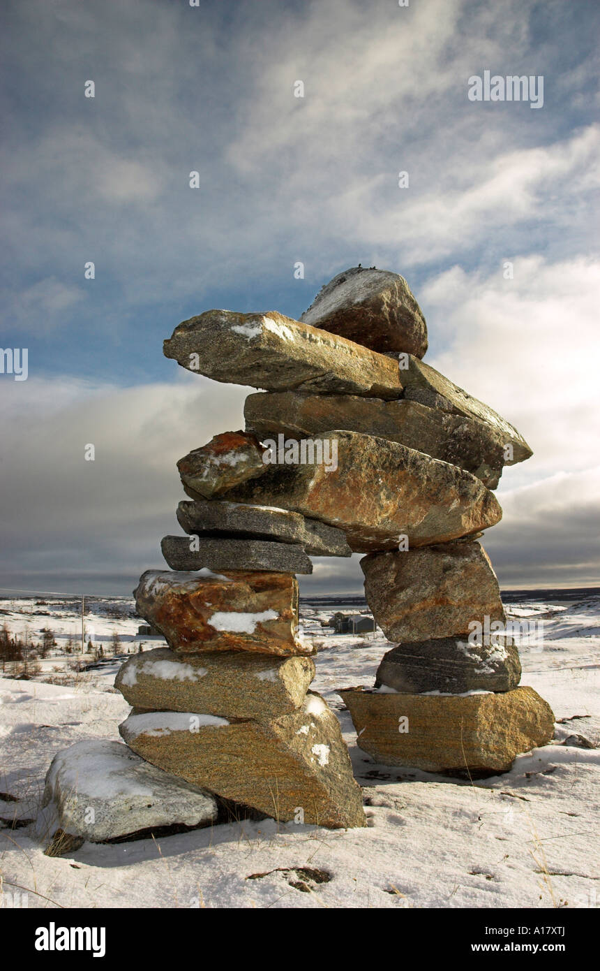 An inukshuk on a hill overlooking the arctic village of Kuujjuaq Stock ...