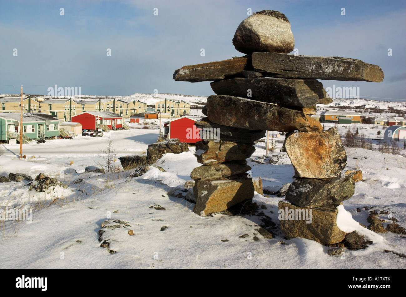 An inukshuk on a hill overlooking the arctic village of Kuujjuaq Stock ...