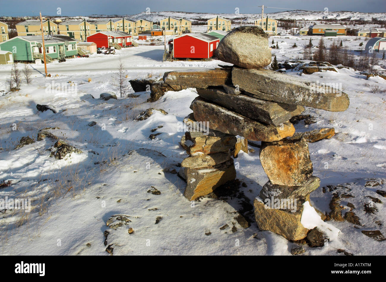 An inukshuk on a hill overlooking the arctic village of Kuujjuaq Stock ...