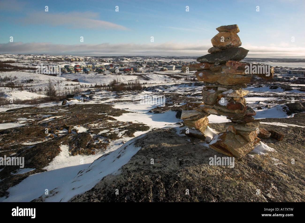 An inukshuk on a hill overlooking the arctic village of Kuujjuaq Stock ...