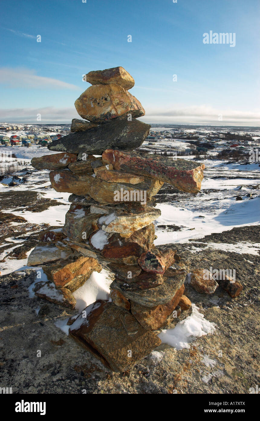 An inukshuk on a hill overlooking the arctic village of Kuujjuaq Stock ...