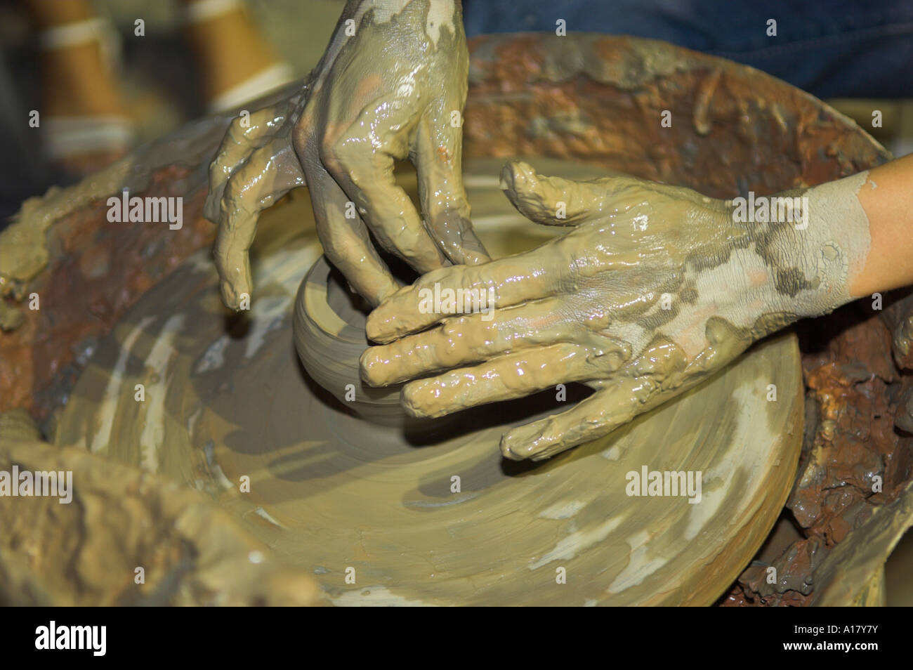 Close up of potters hands throwing a pot on revolving wheel Stock Photo ...