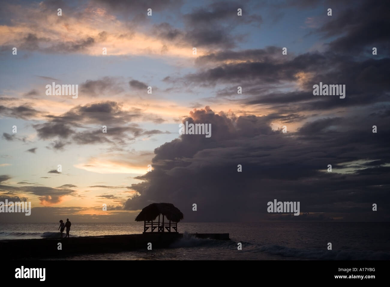 Sun setting over the ocean with rain clouds, Tobago Island Caribbean ...